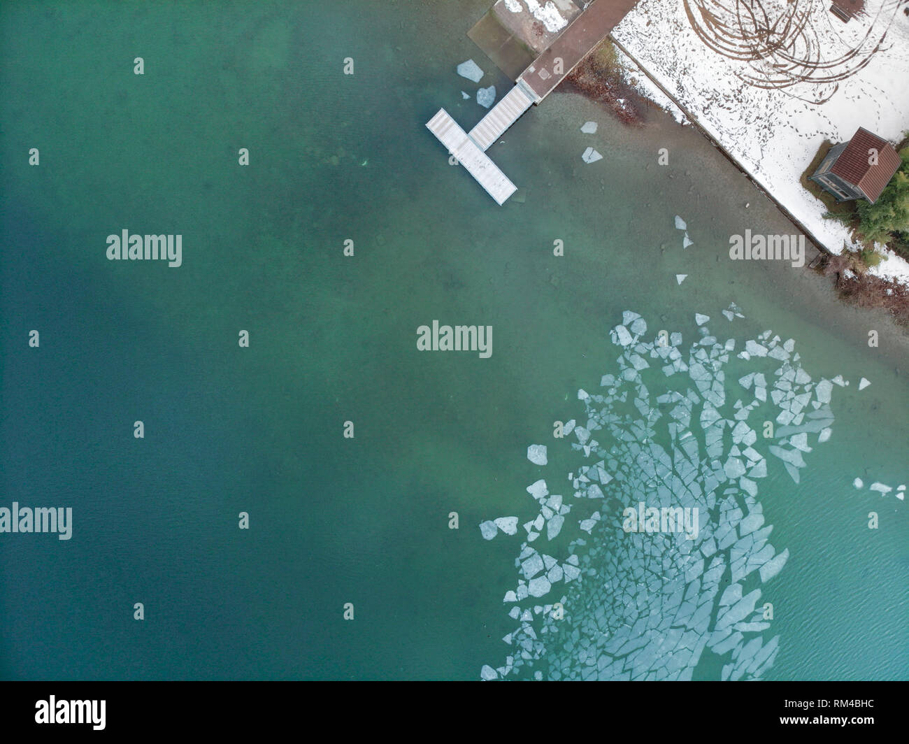 Frozen lake in Vergiate Italy with pier Stock Photo - Alamy