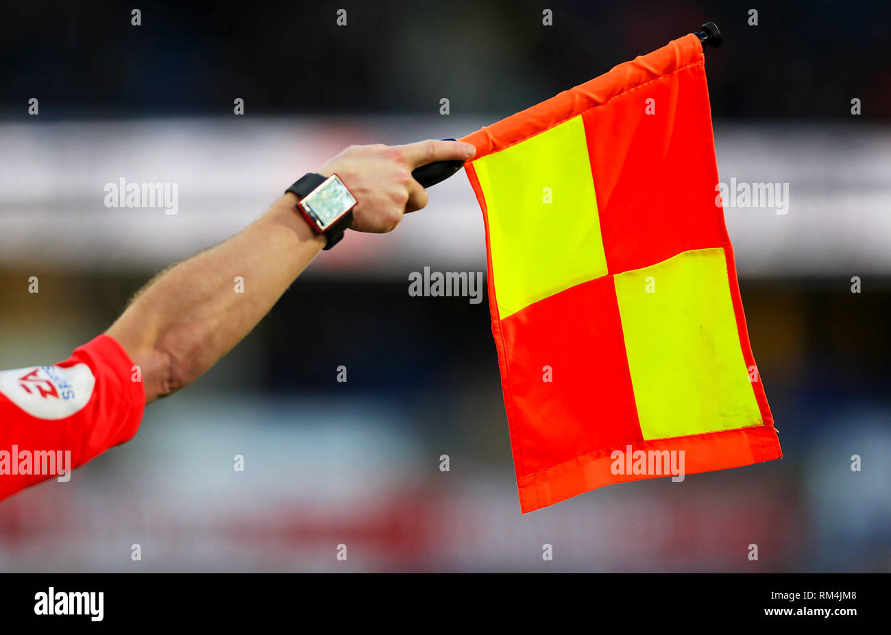 The fourth official raises the offside flag Stock Photo - Alamy
