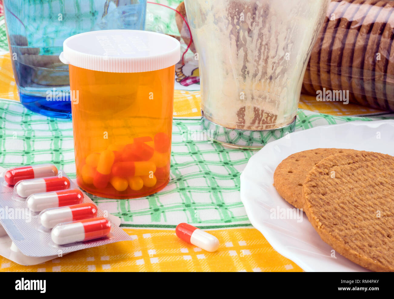 Medication during breakfast, capsules next to a glass of water ...