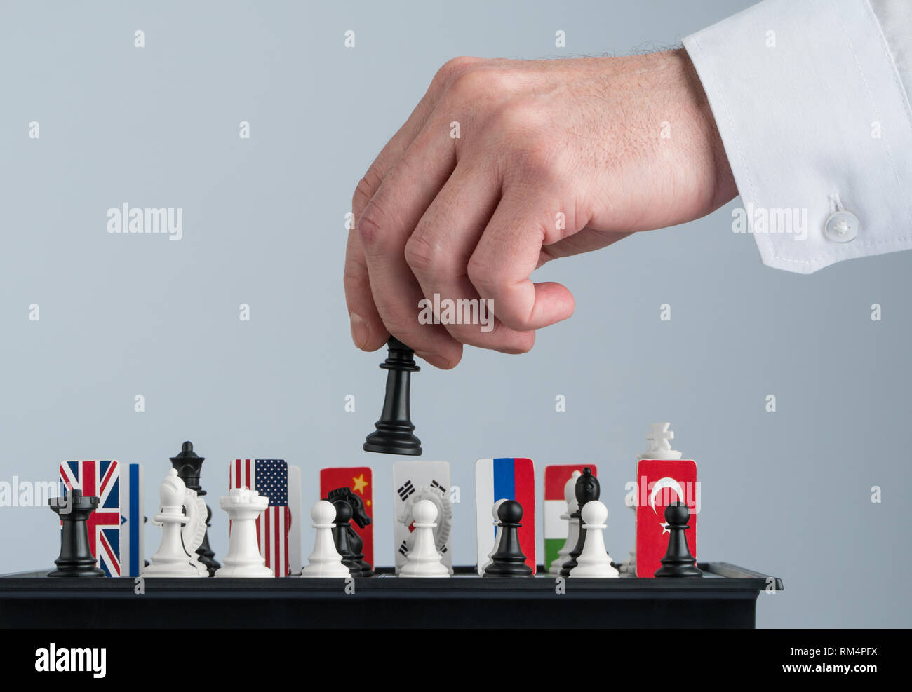 Politician's hand moves a chess piece. Conceptual photo of a political ...
