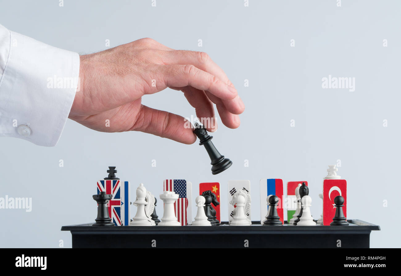 Politician's hand moves a chess piece. Conceptual photo of a political ...