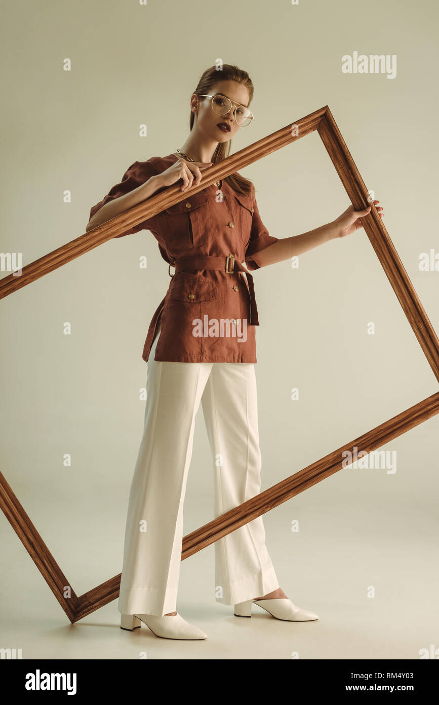 beautiful fashionable girl in vintage style posing with big wooden ...