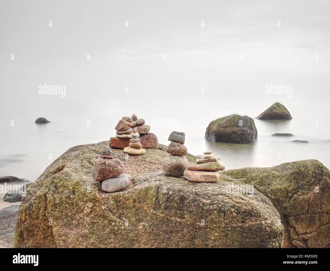 Stack of pebble stone on shingle beach. Pile of stacked stones on the ...