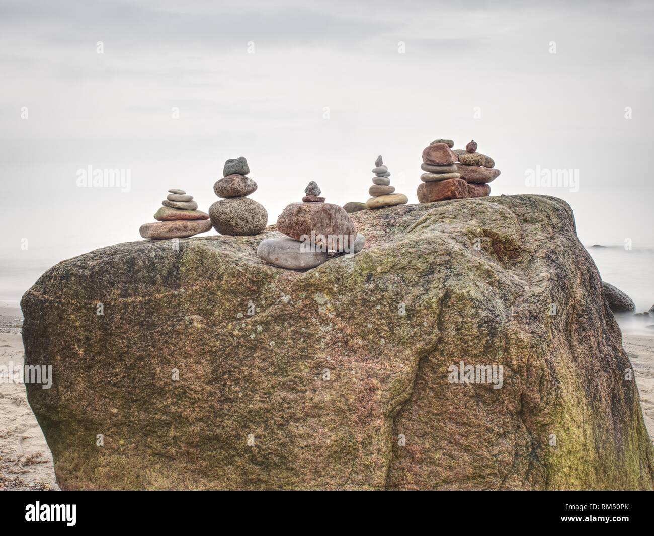 Stack of pebble stone on shingle beach. Pile of stacked stones on the ...