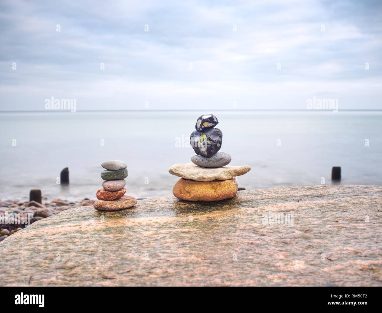 Zen stones pyramids in the beach. Stack of stone on the beach. Balance ...