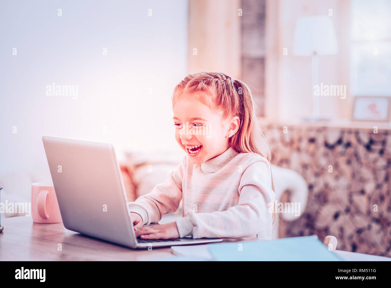 Modern child feeling happy while playing computer game Stock Photo - Alamy