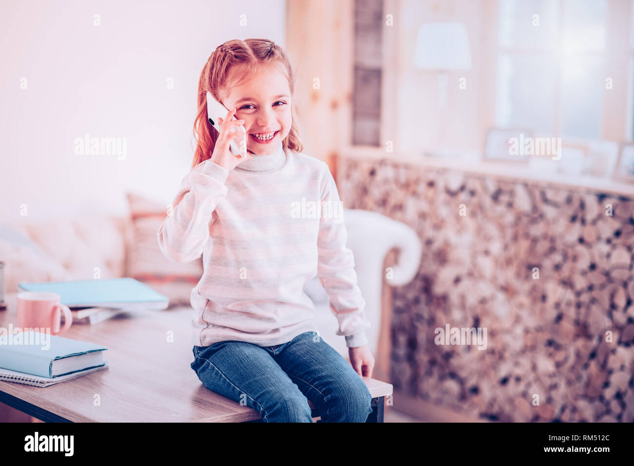 Child talking on big phone with her mother Stock Photo - Alamy