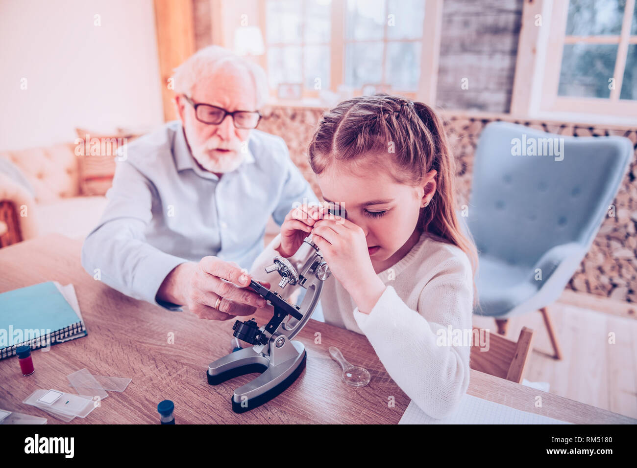 Personal teacher explaining how watching in microscope Stock Photo - Alamy