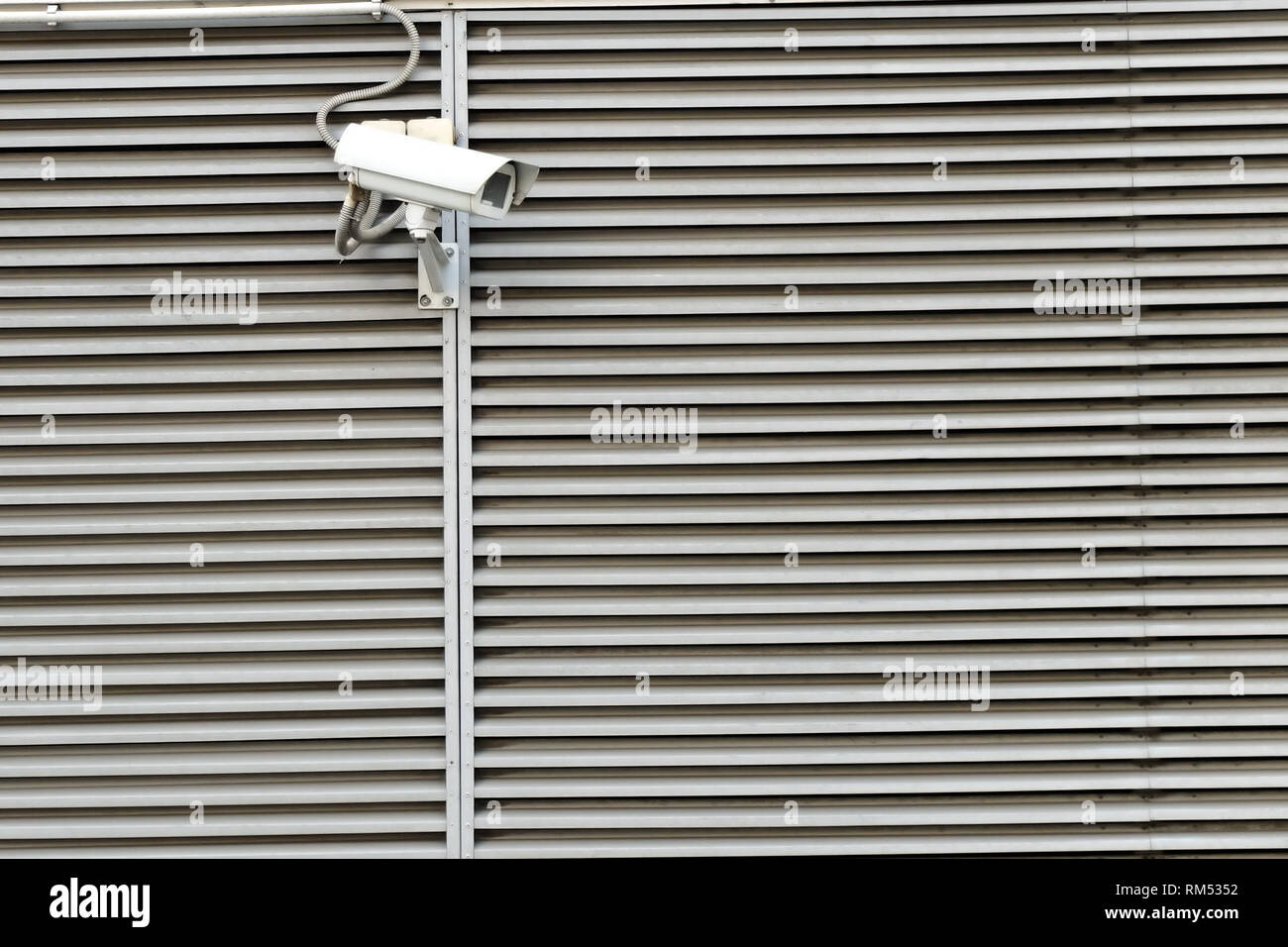 Security camera on modern a building horizontal stripes wall Stock ...