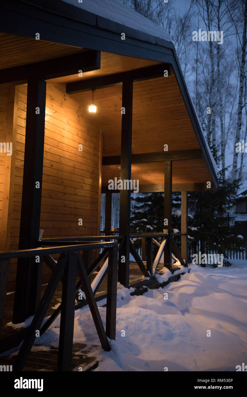 A beautiful architectured modern house in winter forest. Side view ...