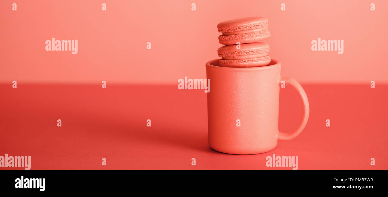 sweet macarons in cup on trendy Living coral background. Pantone color ...