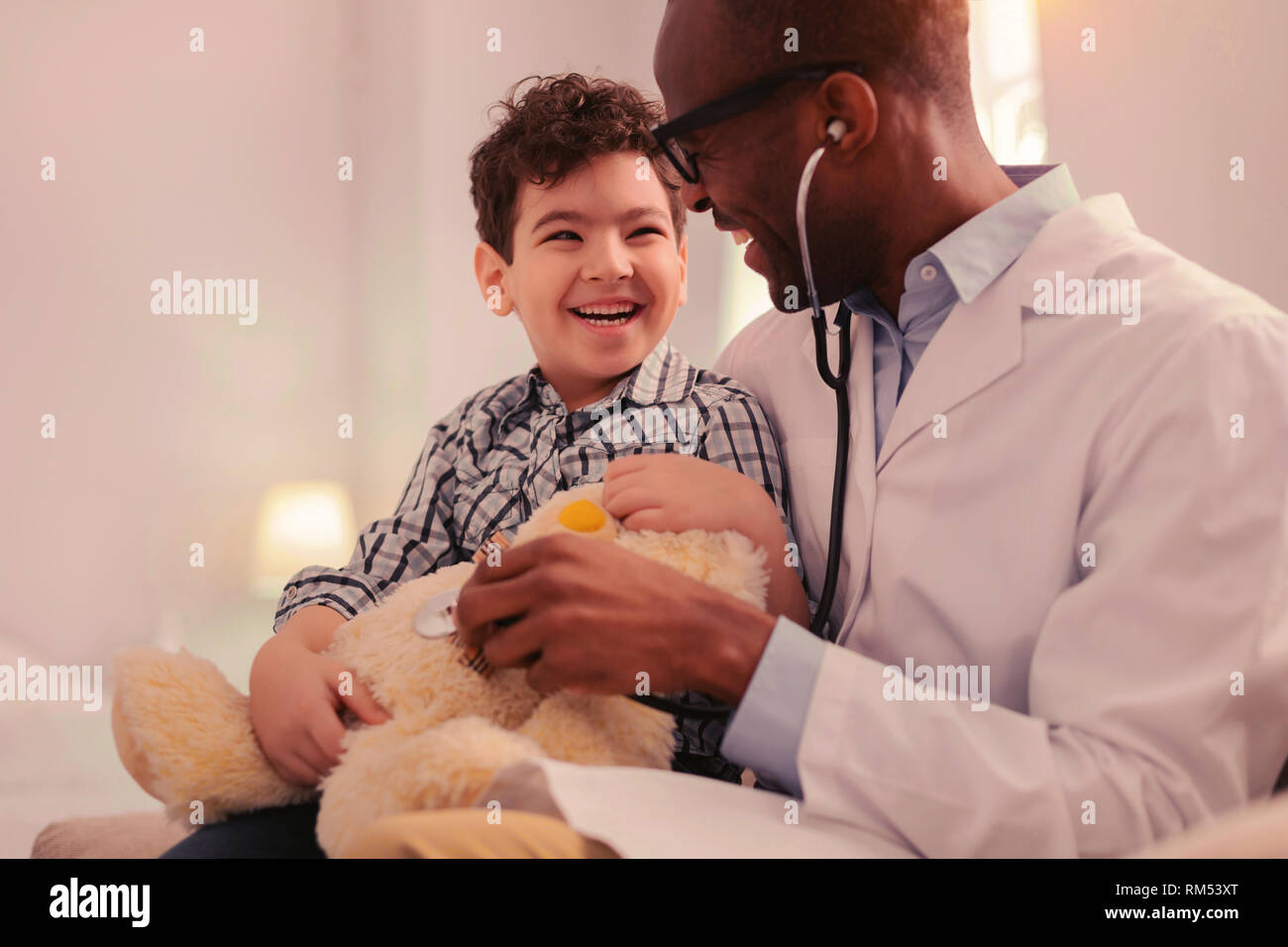 A doctor showing to kid basics of medicine Stock Photo - Alamy