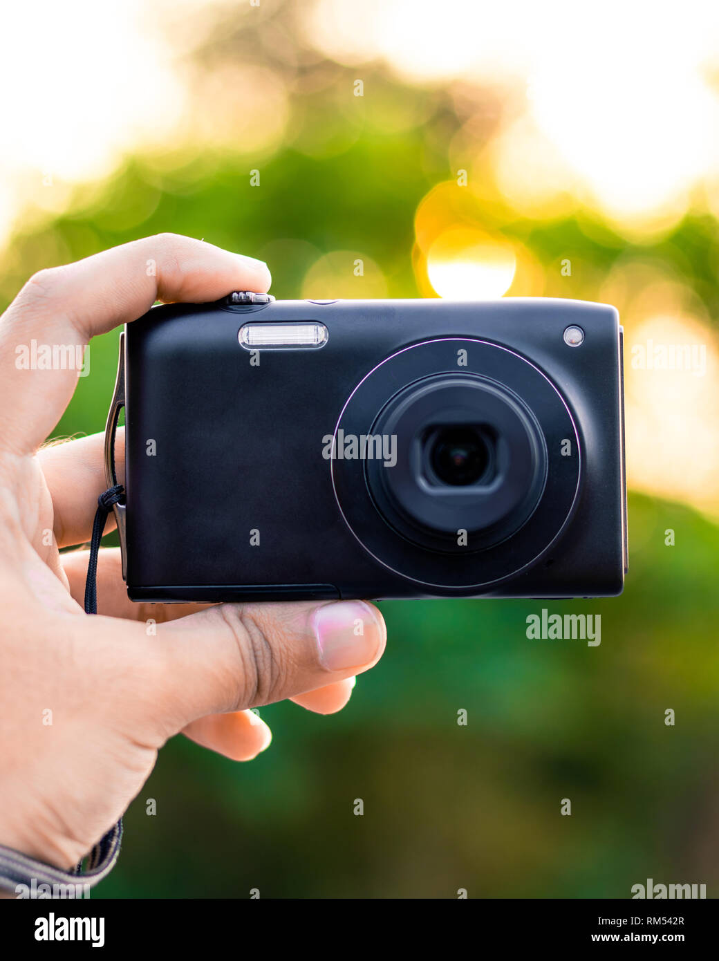 A small black digital camera in the hand Stock Photo - Alamy