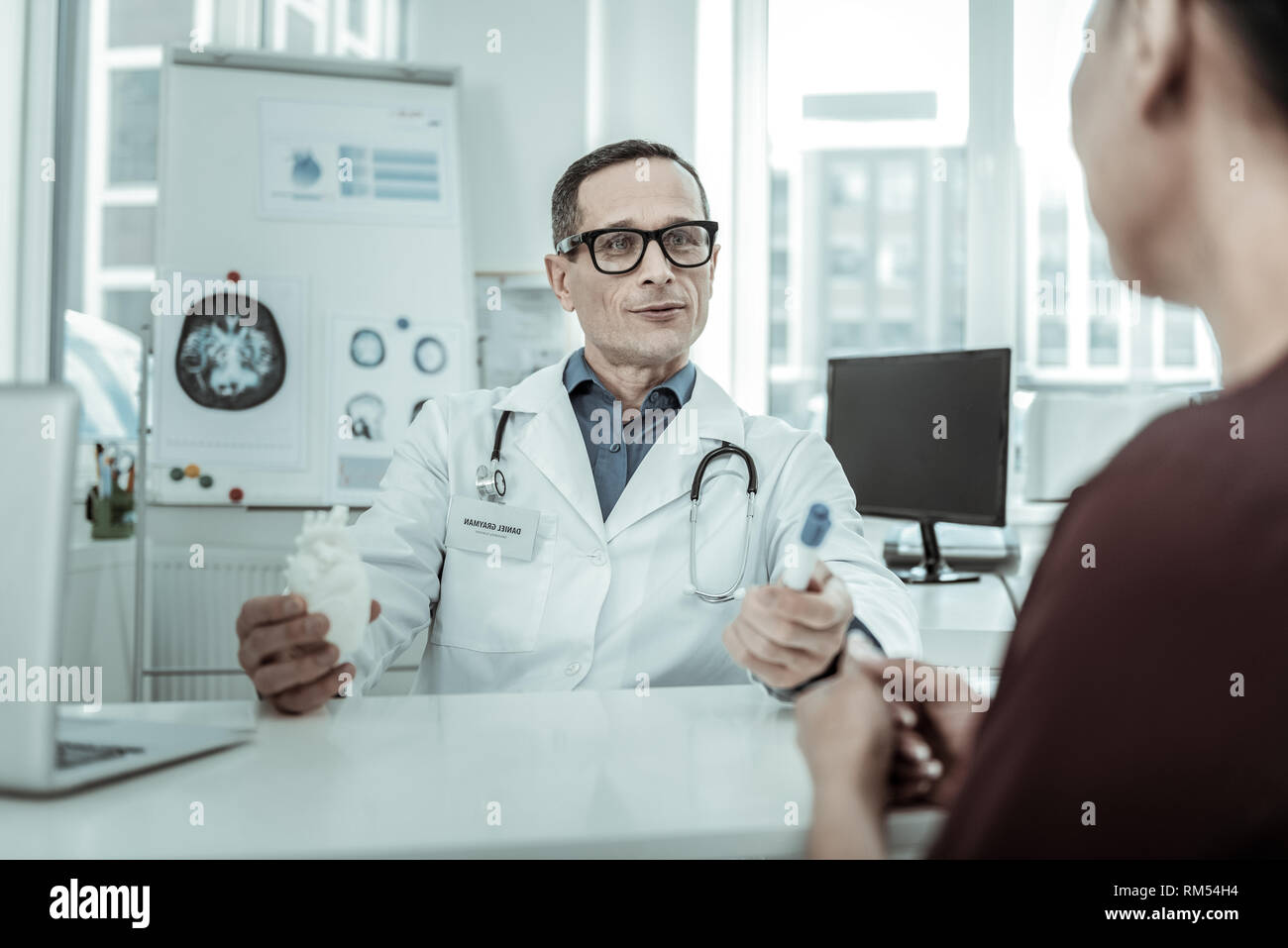 Professional cardiologist having session with his patient Stock Photo ...