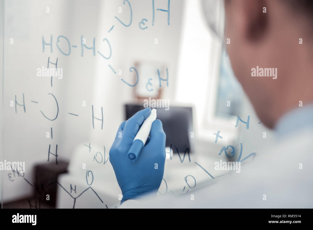 Scientist writing chemical formulas on the glass Stock Photo - Alamy