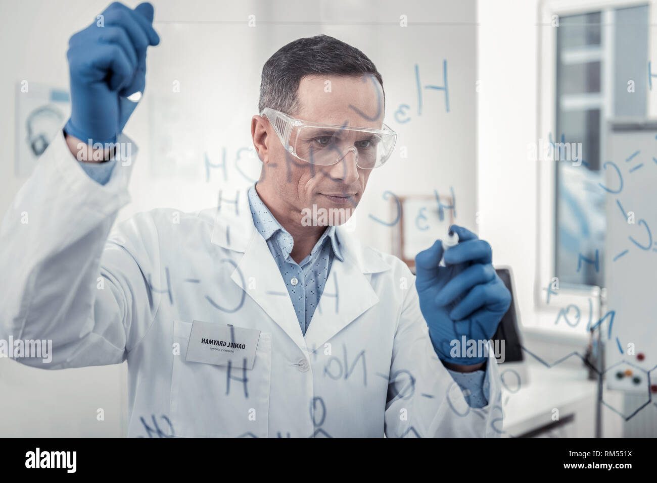 Scientist working out the formula of new material Stock Photo - Alamy