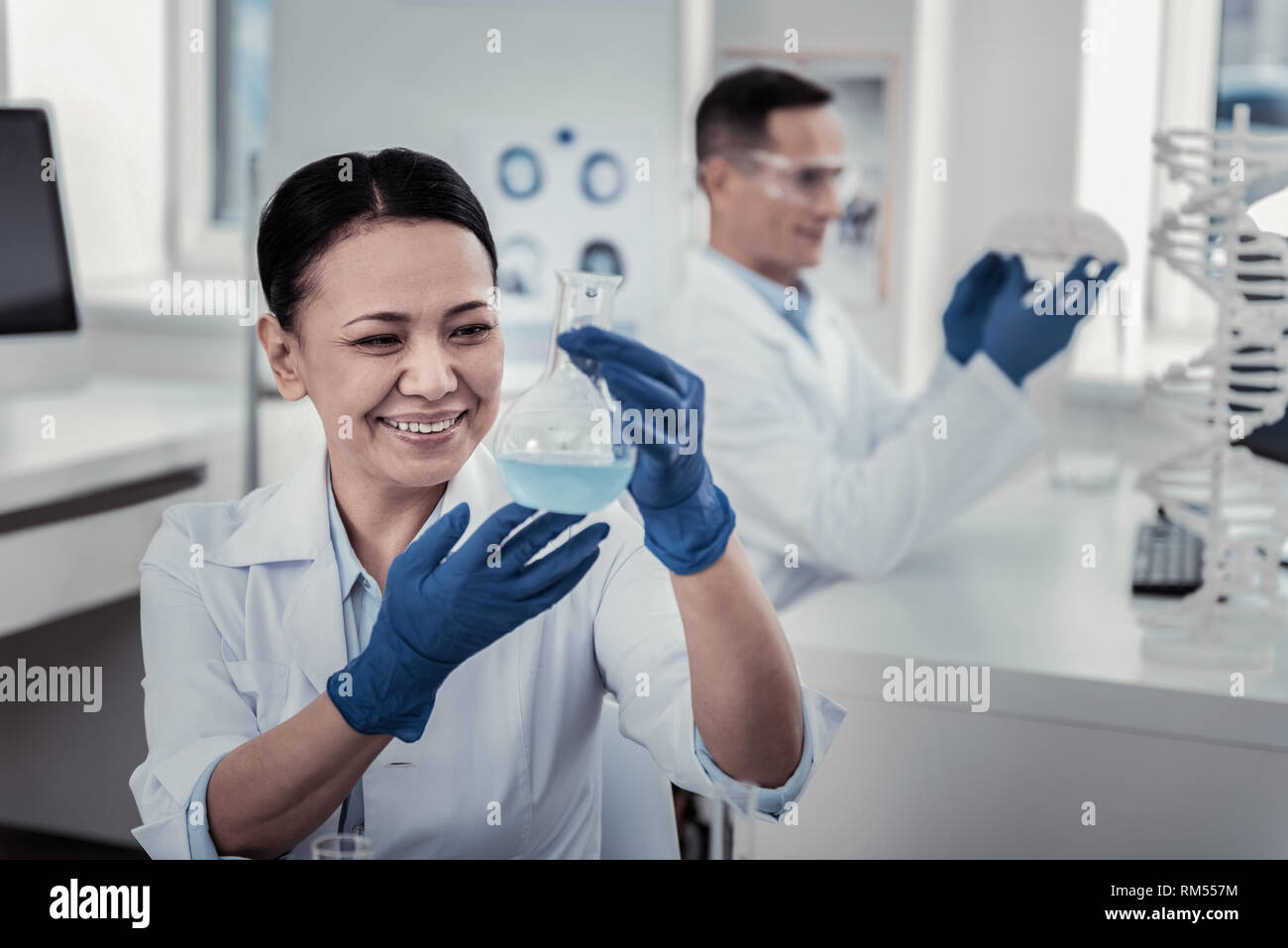 Scientist making the experiment with the flask Stock Photo - Alamy