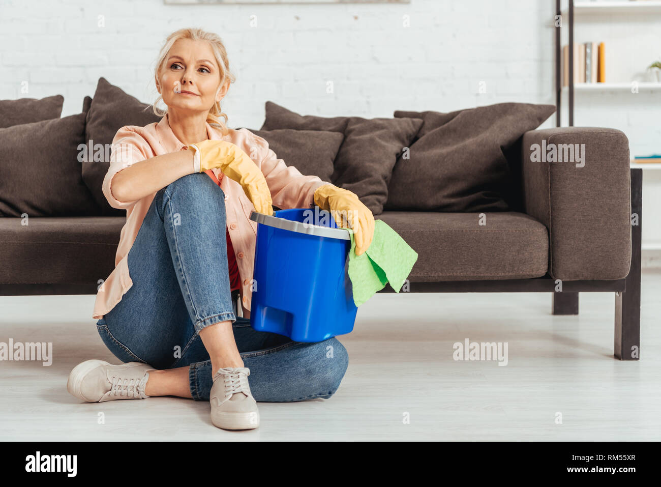 Senior woman sitting on floor hi-res stock photography and images - Alamy