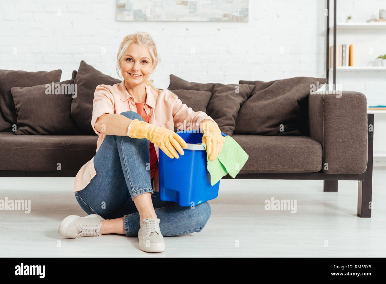 Senior woman sitting on floor hi-res stock photography and images - Alamy