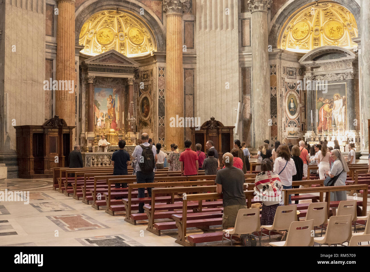 people praying at the altar of St. Joseph, St. Peter's Basilica, San ...
