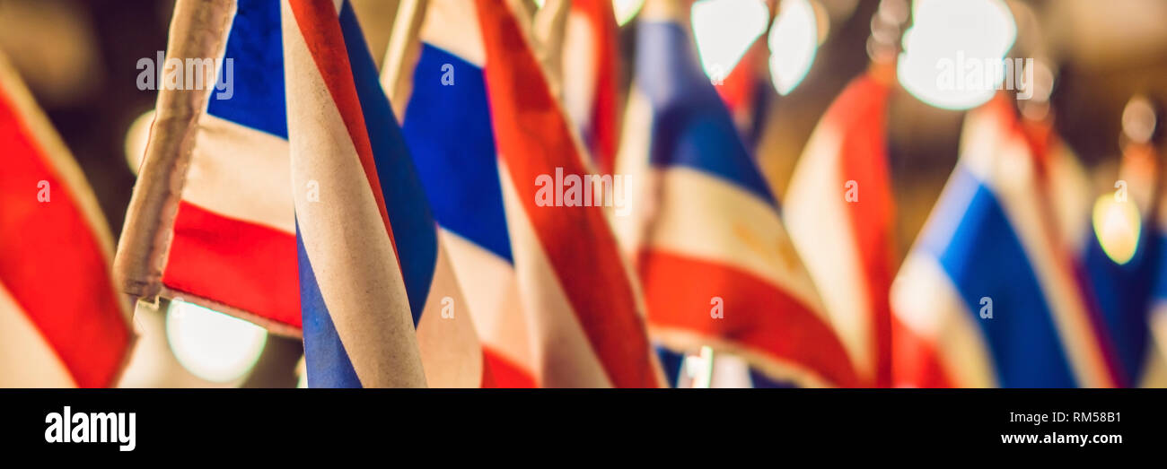 ten small Thai flags indoors on the background of bokeh lights BANNER ...