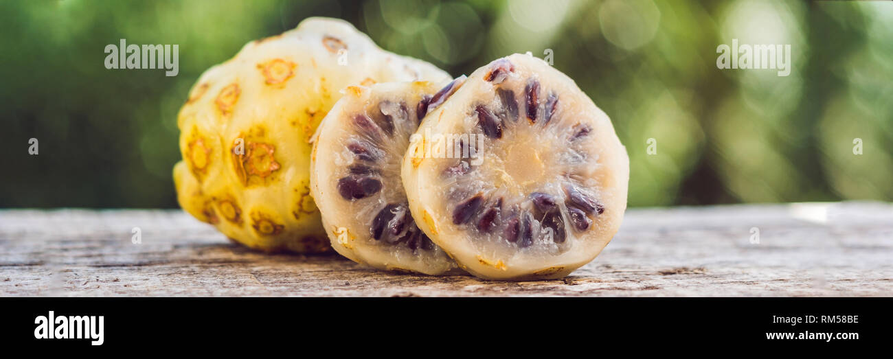 fresh noni fruit and noni slice on wooden background and space.slice of ...