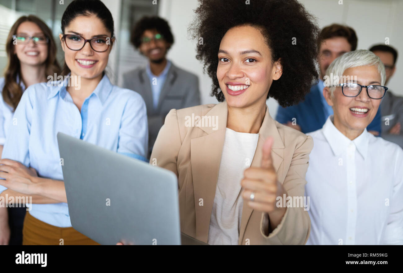 Successful company with happy workers in office Stock Photo - Alamy
