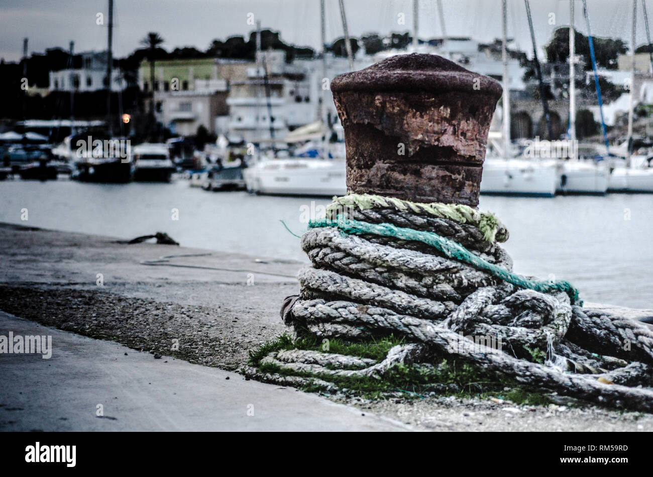 rusty bollard with rope Stock Photo - Alamy