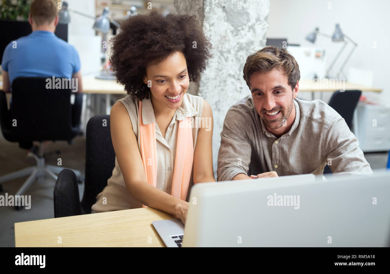 Group of business people collaborating on project in office Stock Photo ...