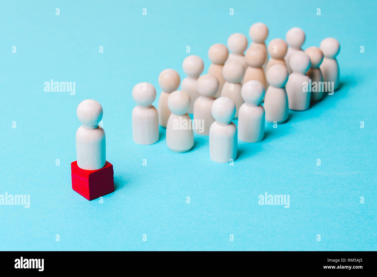 Wooden figures on a blue background. Leader and team. Business ...