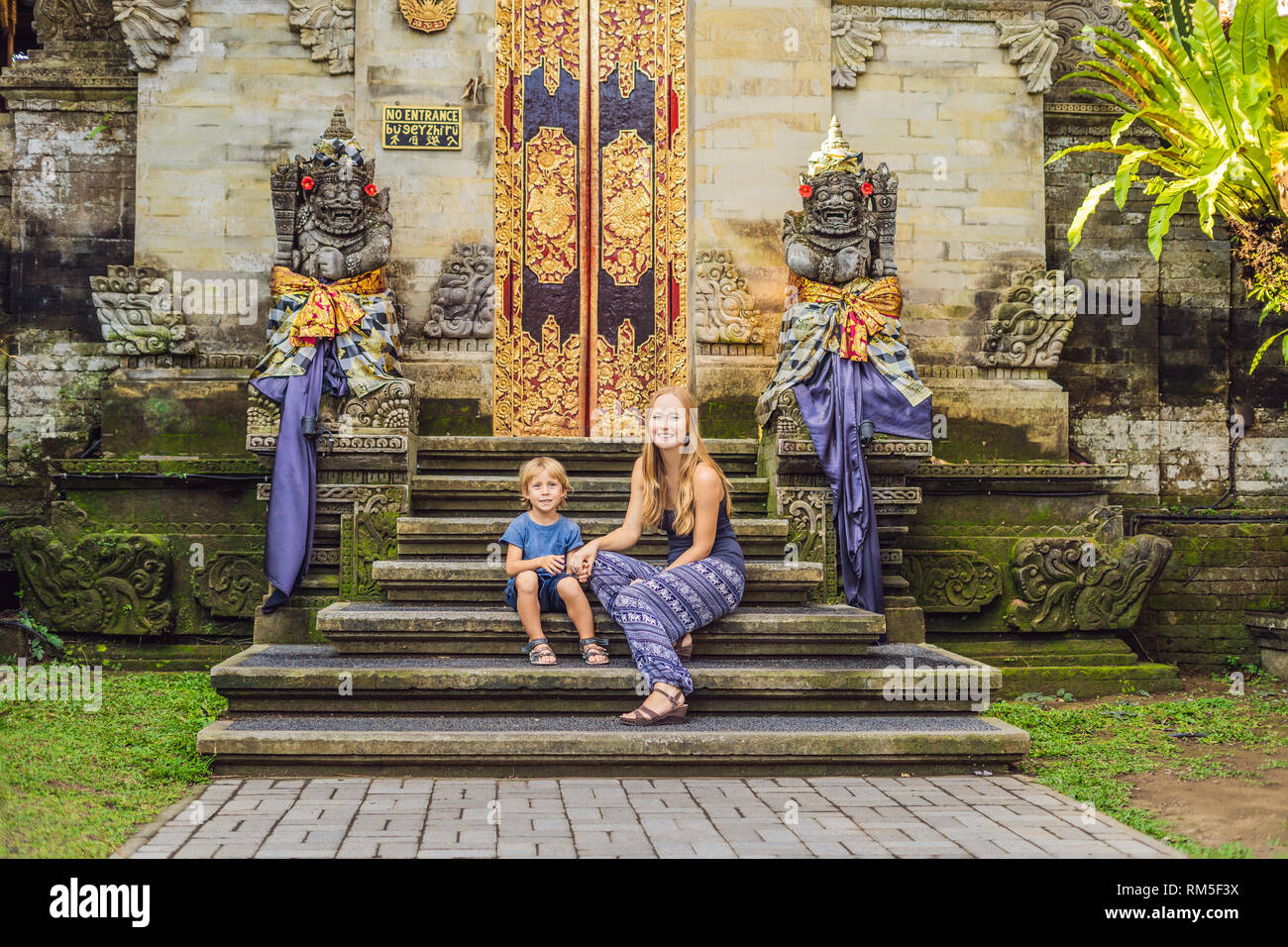 Mom and son tourists in Ubud palace, Bali - Inside the Ubud palace ...
