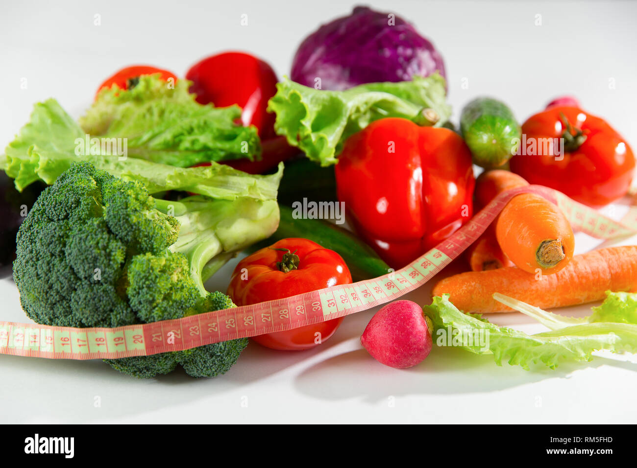 Vegetables and measuring tape, still life isolated on white background ...