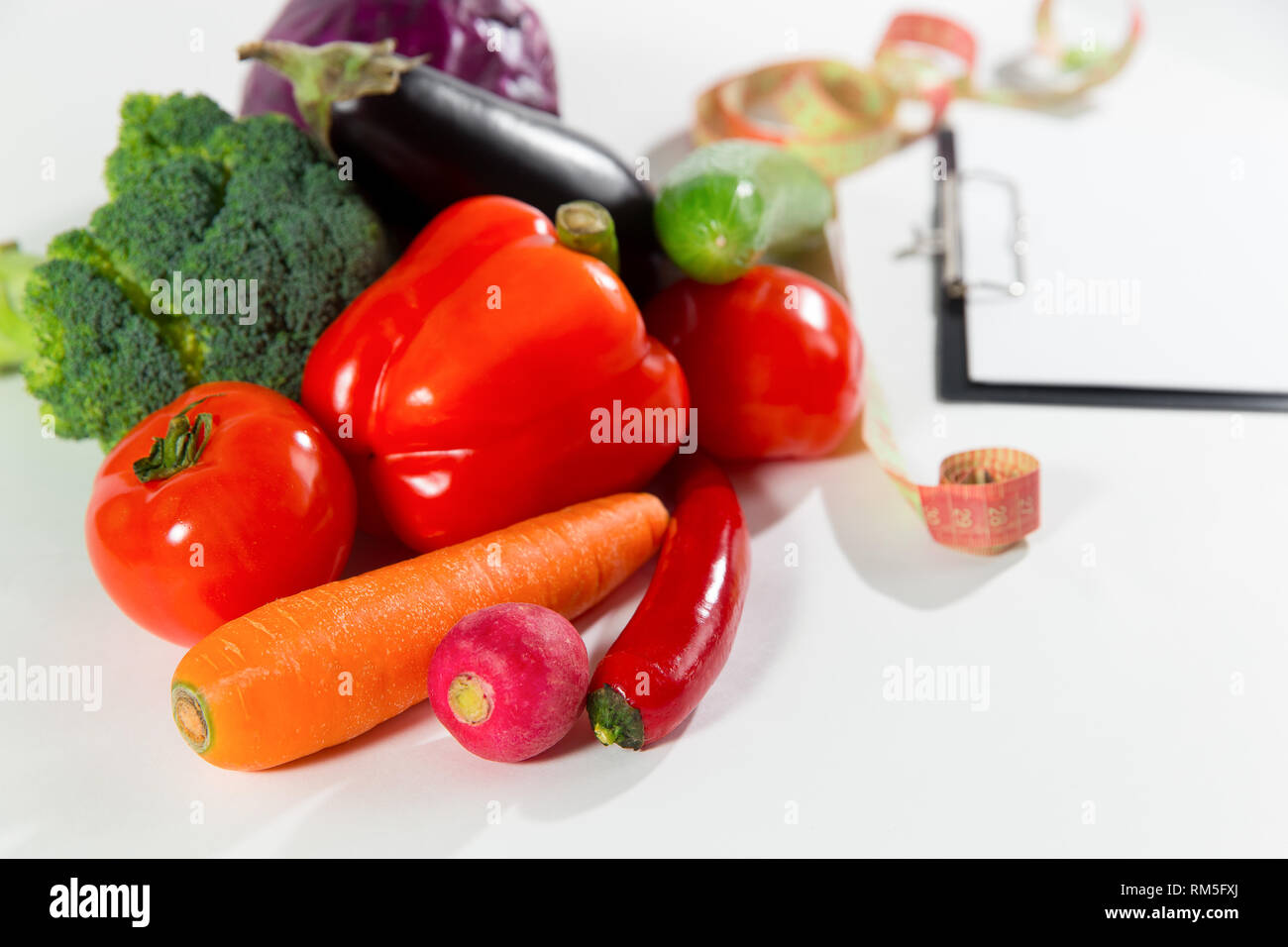 Fresh vegetables, measuring tape and diet plan Stock Photo - Alamy