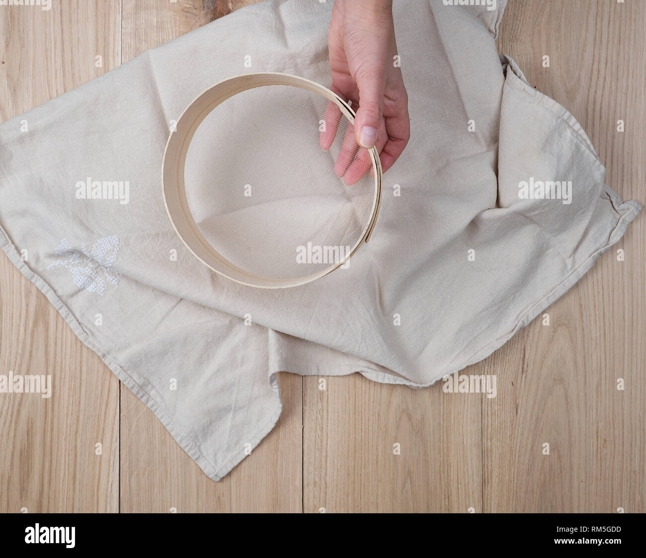 empty round wooden sieve in hand, top view Stock Photo - Alamy
