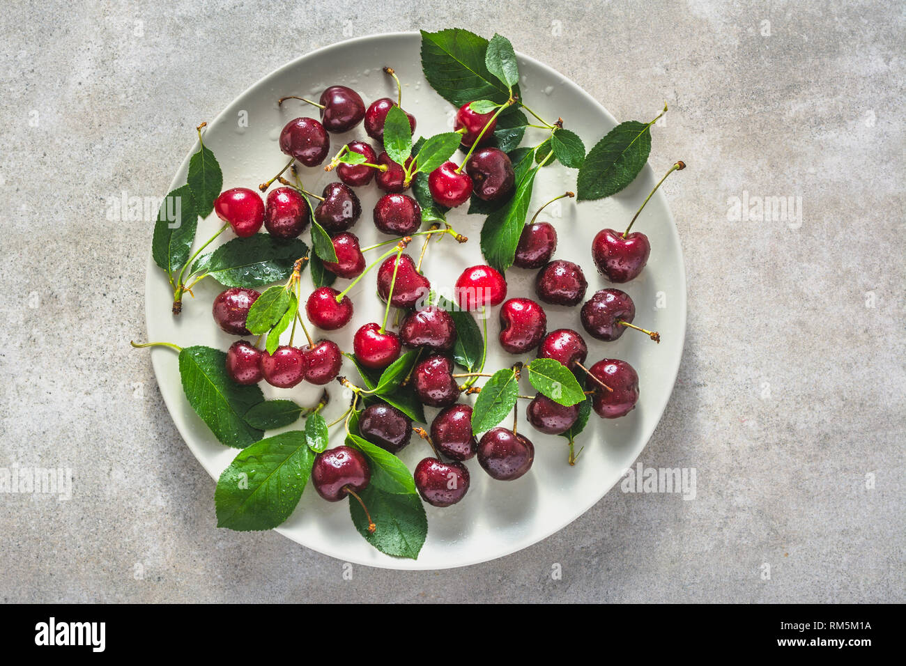 Fresh cherries on plate. Red sweet cherry fruit, flat lay, top view ...