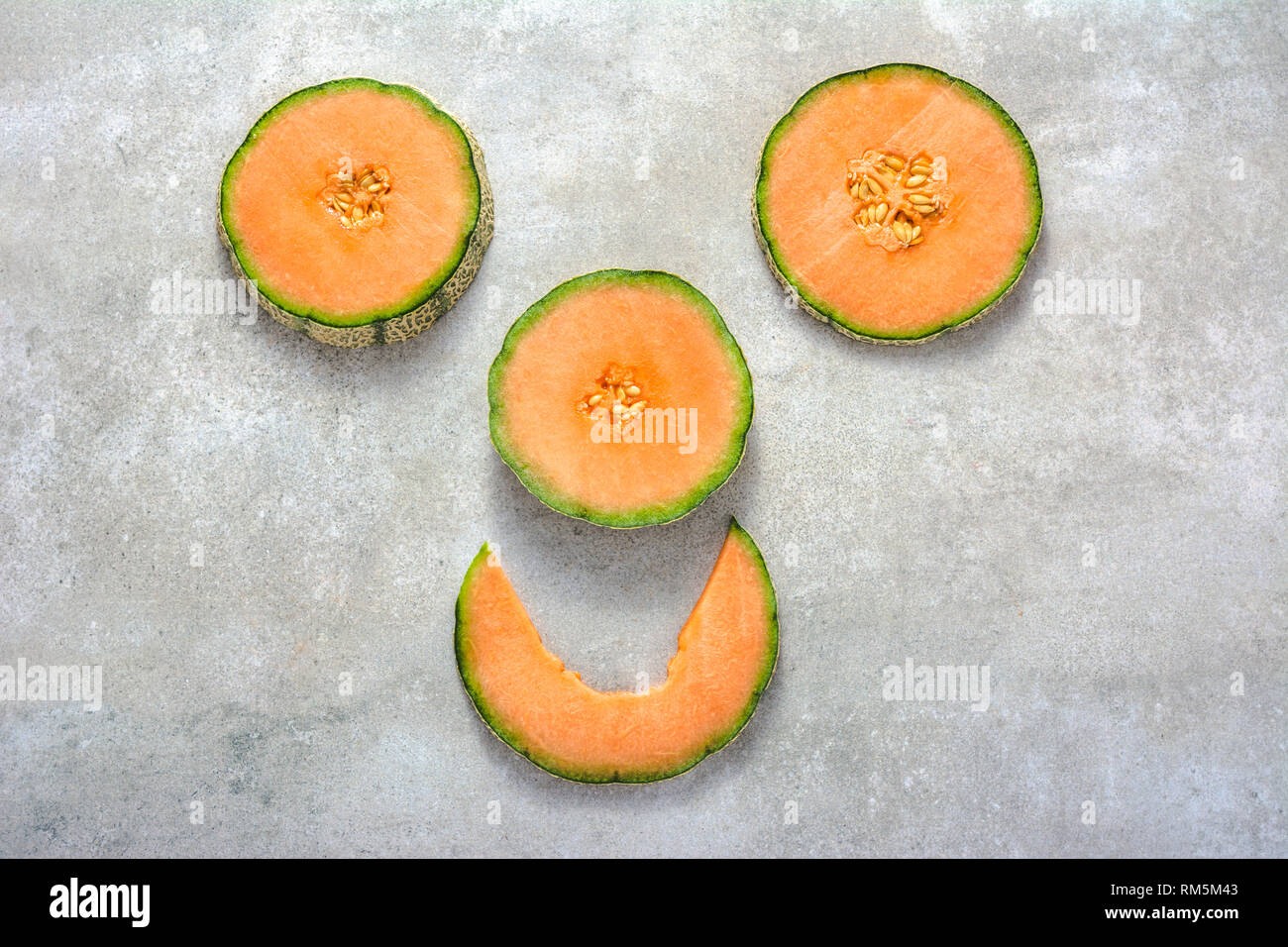 Juicy melon with smile face. Funny watermelon on white background, top ...