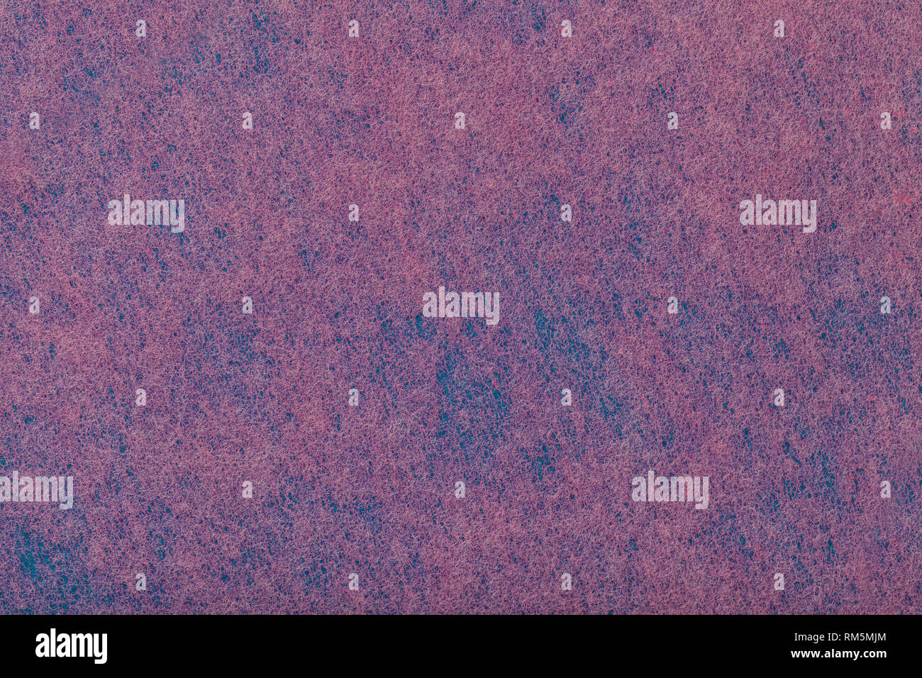 Construction of dark purple background with blue spots of felt fabric ...