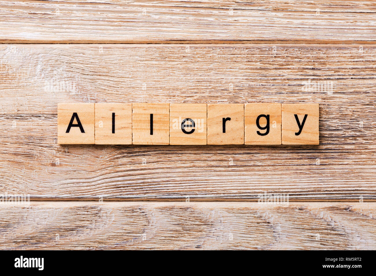 Allergy word written on wood block. Allergy text on wooden table for ...