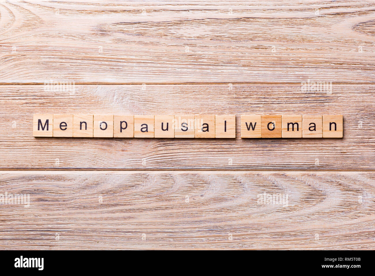 menopausal woman word written on wood block. menopausal woman text on ...