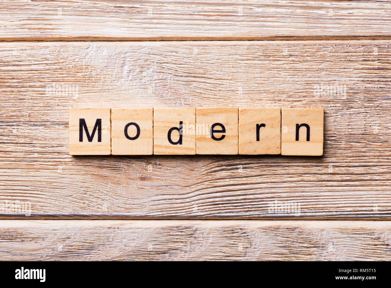modern word written on wood block. modern text on wooden table for your ...