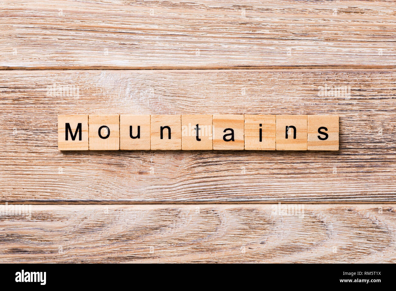 mountains word written on wood block. mountains text on wooden table ...