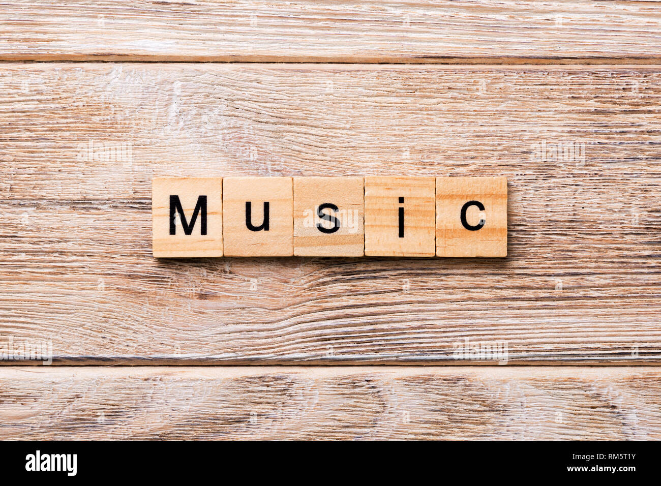 MUSIC word written on wood block. MUSIC text on wooden table for your ...