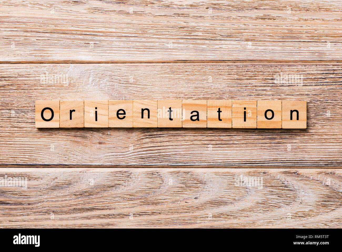 Orientation word written on wood block. Orientation text on wooden ...