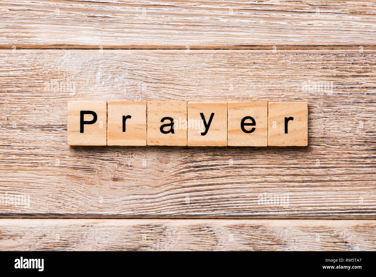 PRAYER word written on wood block. PRAYER text on wooden table for your ...