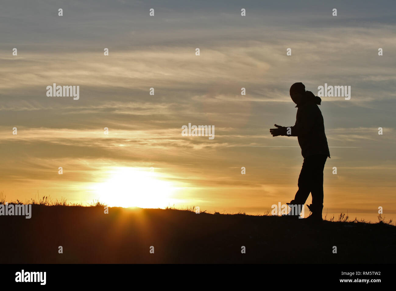 Silhouette men on the background of an incredible sunset Stock Photo ...