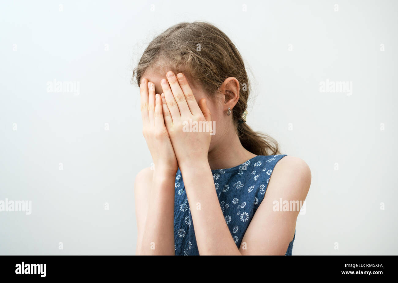 Sad little girl crying at home Stock Photo - Alamy