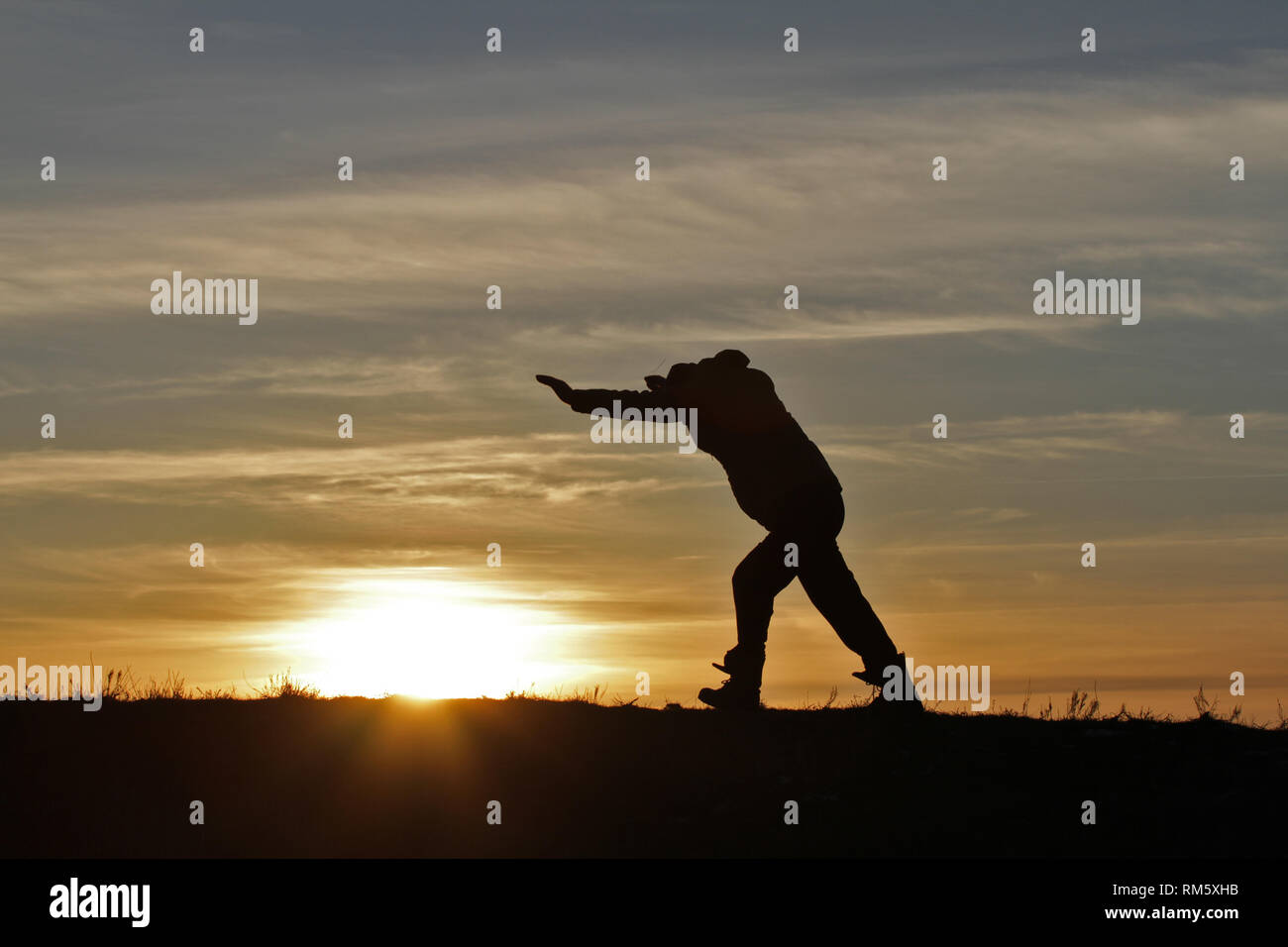Silhouette men on the background of an incredible sunset Stock Photo ...