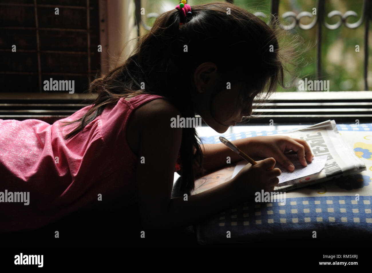 Little girl busy with homework Stock Photo - Alamy