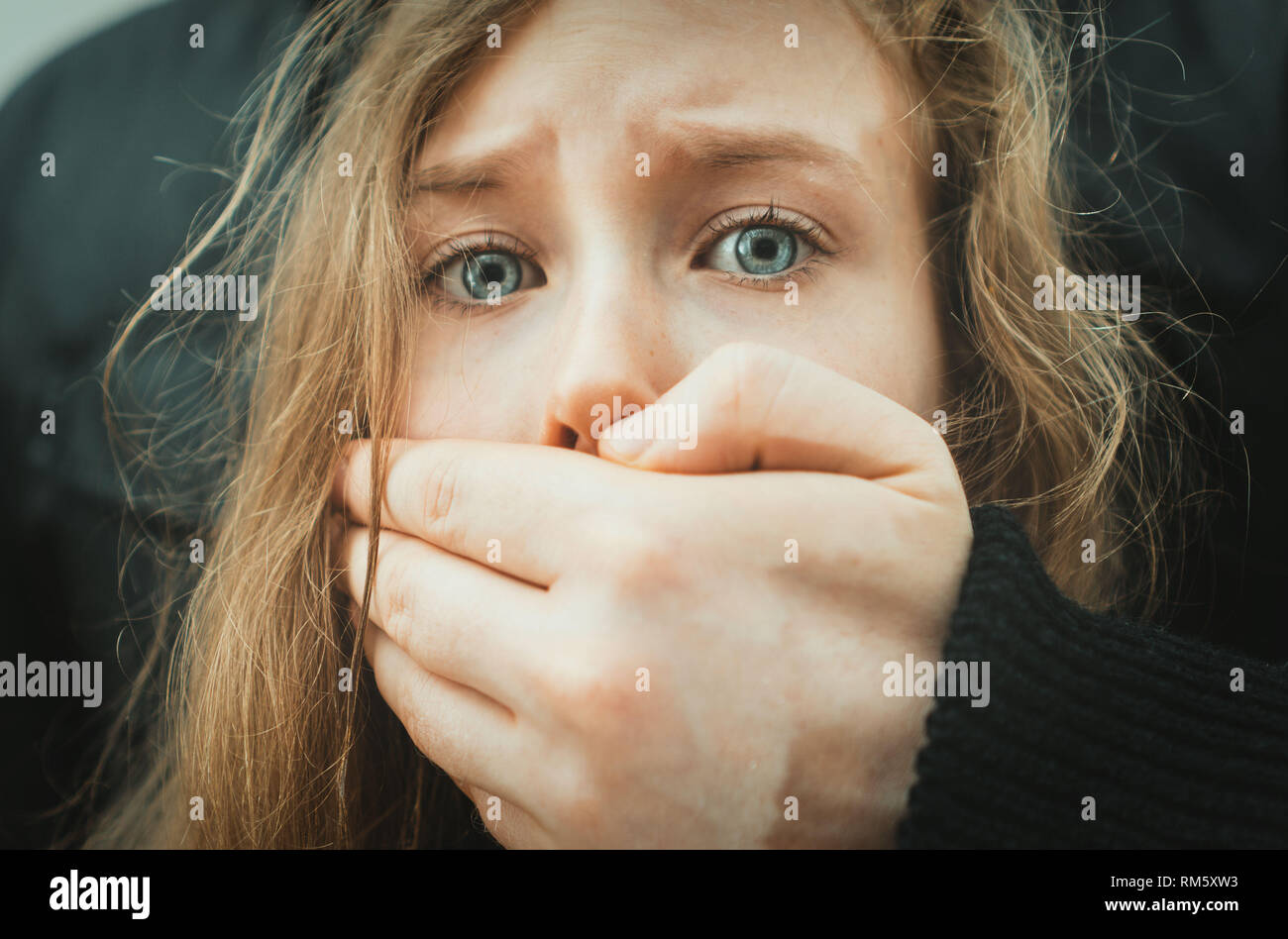 Man's hand covering mouth of scared young girl Stock Photo - Alamy