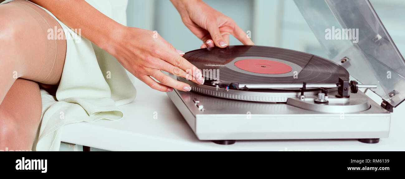 partial view of pin up girl putting vinyl record on record player Stock ...